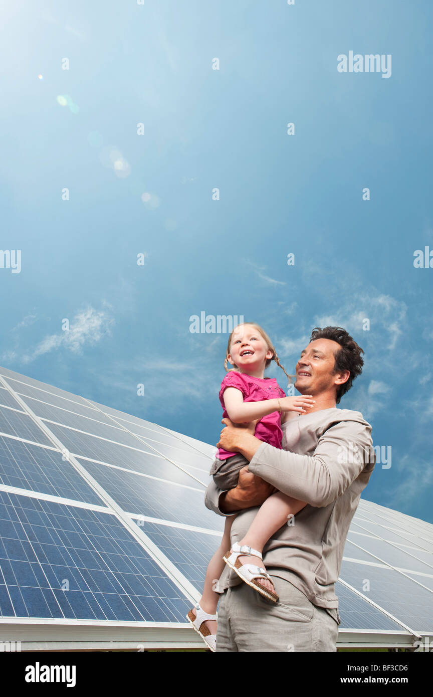 Man and daugther in front of solar panel Stock Photo - Alamy