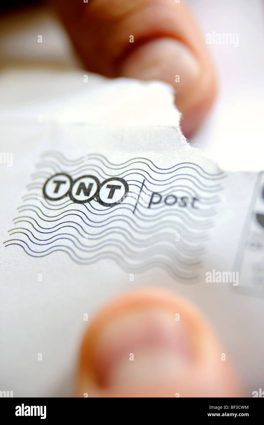 A man opens a letter delivered by TNT Stock Photo - Alamy