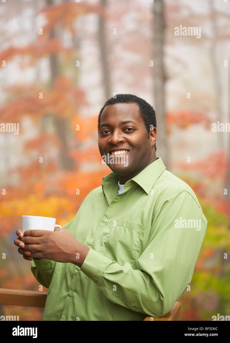 African man holding cup of coffee Stock Photo - Alamy
