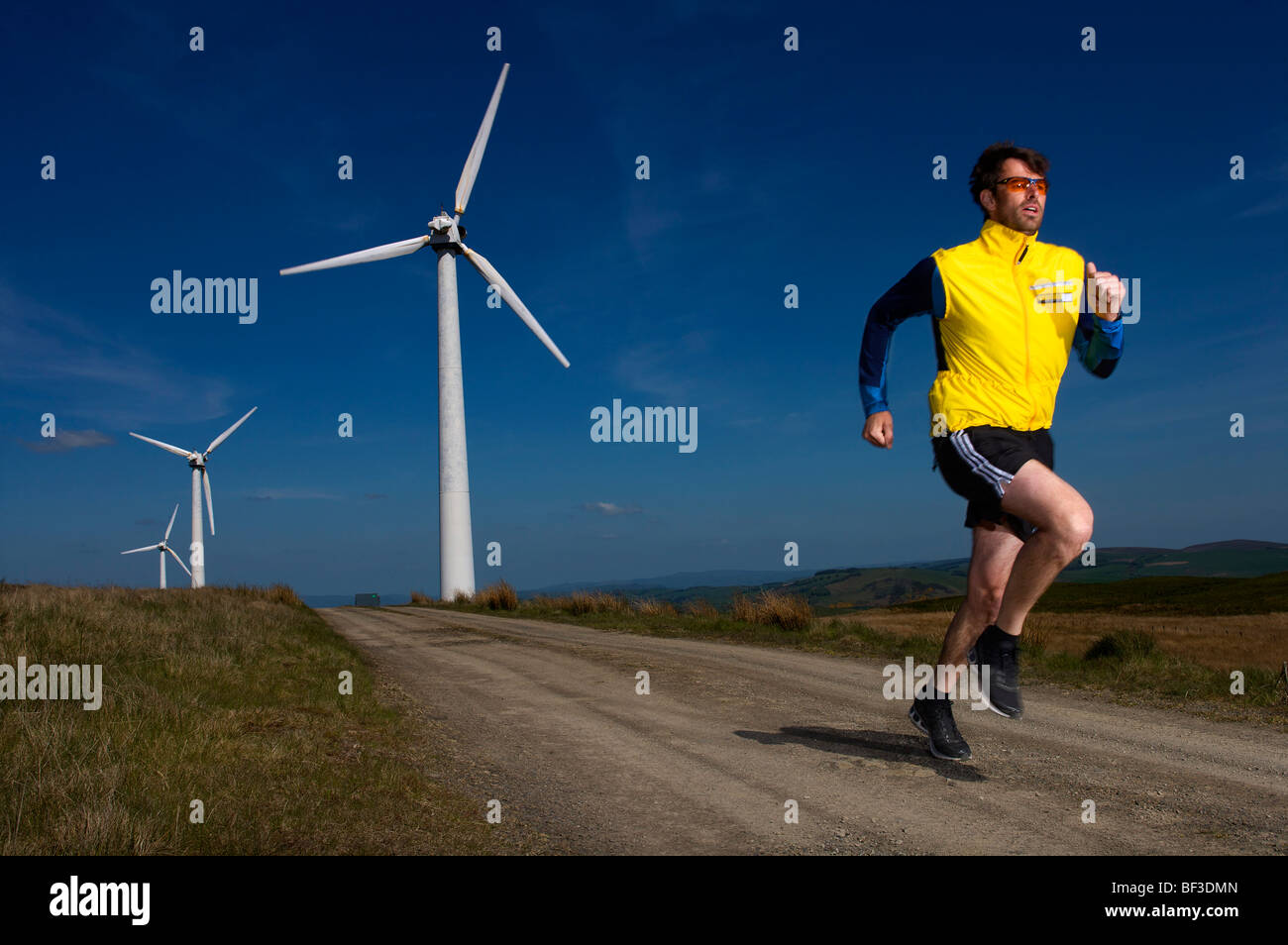 Runner at a wind farm Stock Photo - Alamy