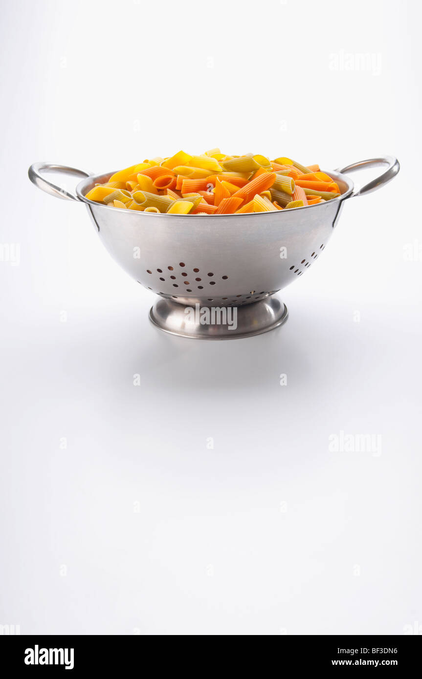 Multi colored rigatoni pasta in a strainer Stock Photo - Alamy
