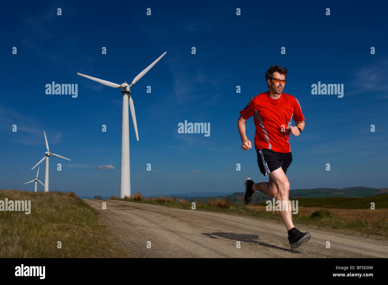 Runner at a wind farm Stock Photo - Alamy