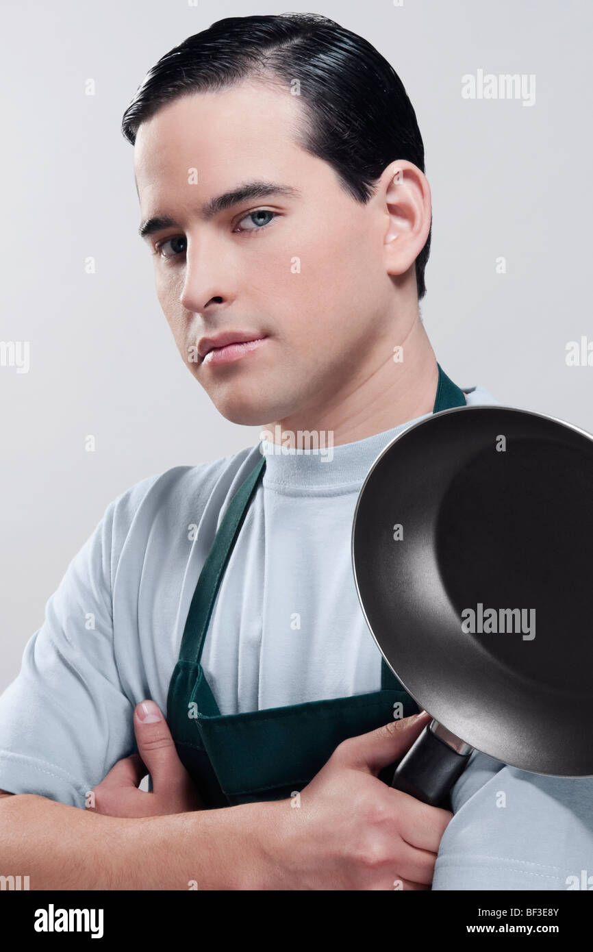 Portrait of a man holding a frying pan Stock Photo - Alamy