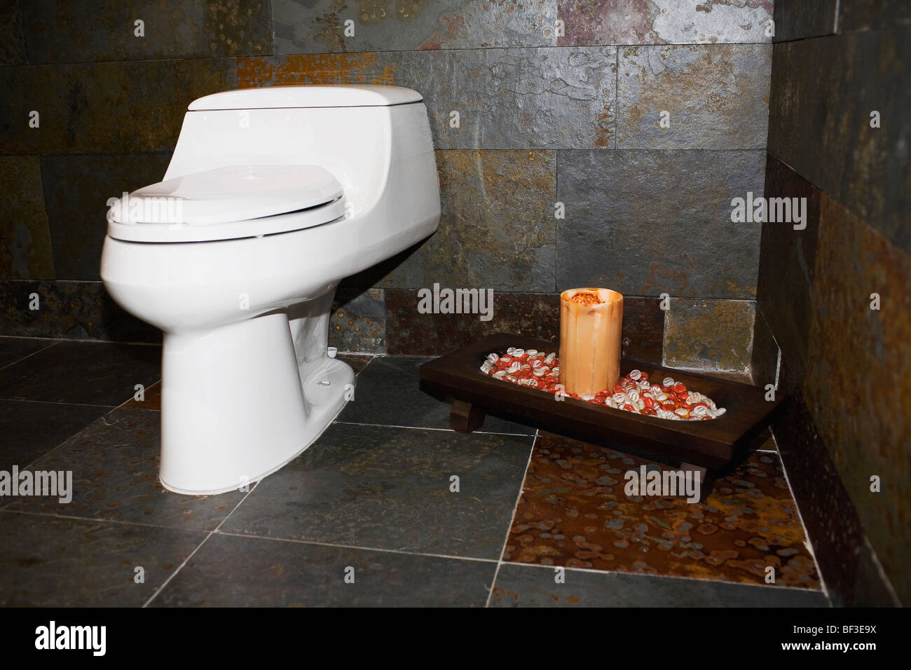 Toilet bowl with a candle in the bathroom Stock Photo - Alamy