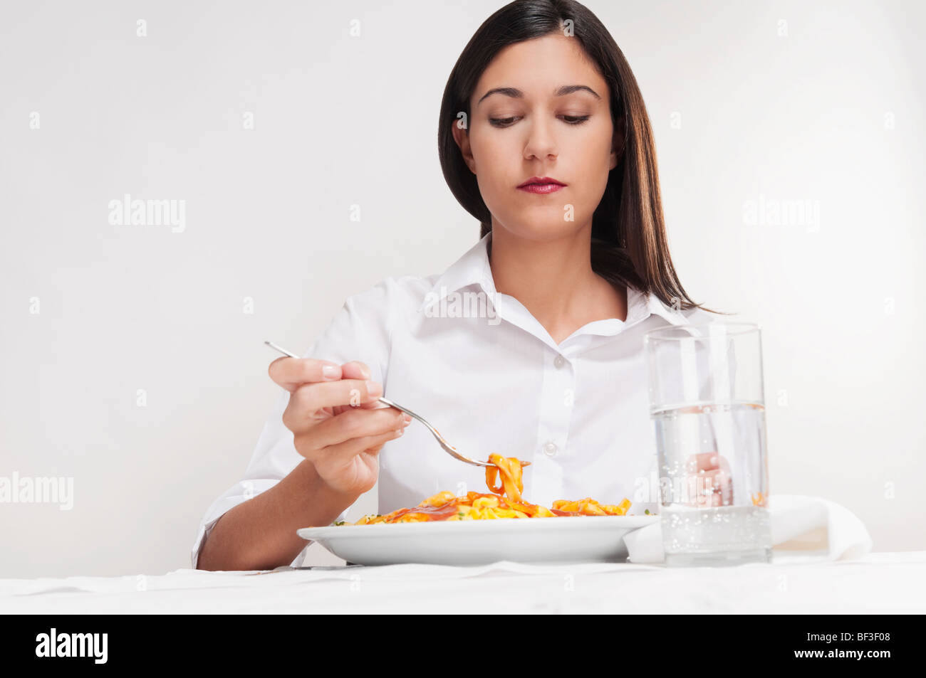 Woman eating pasta Stock Photo - Alamy