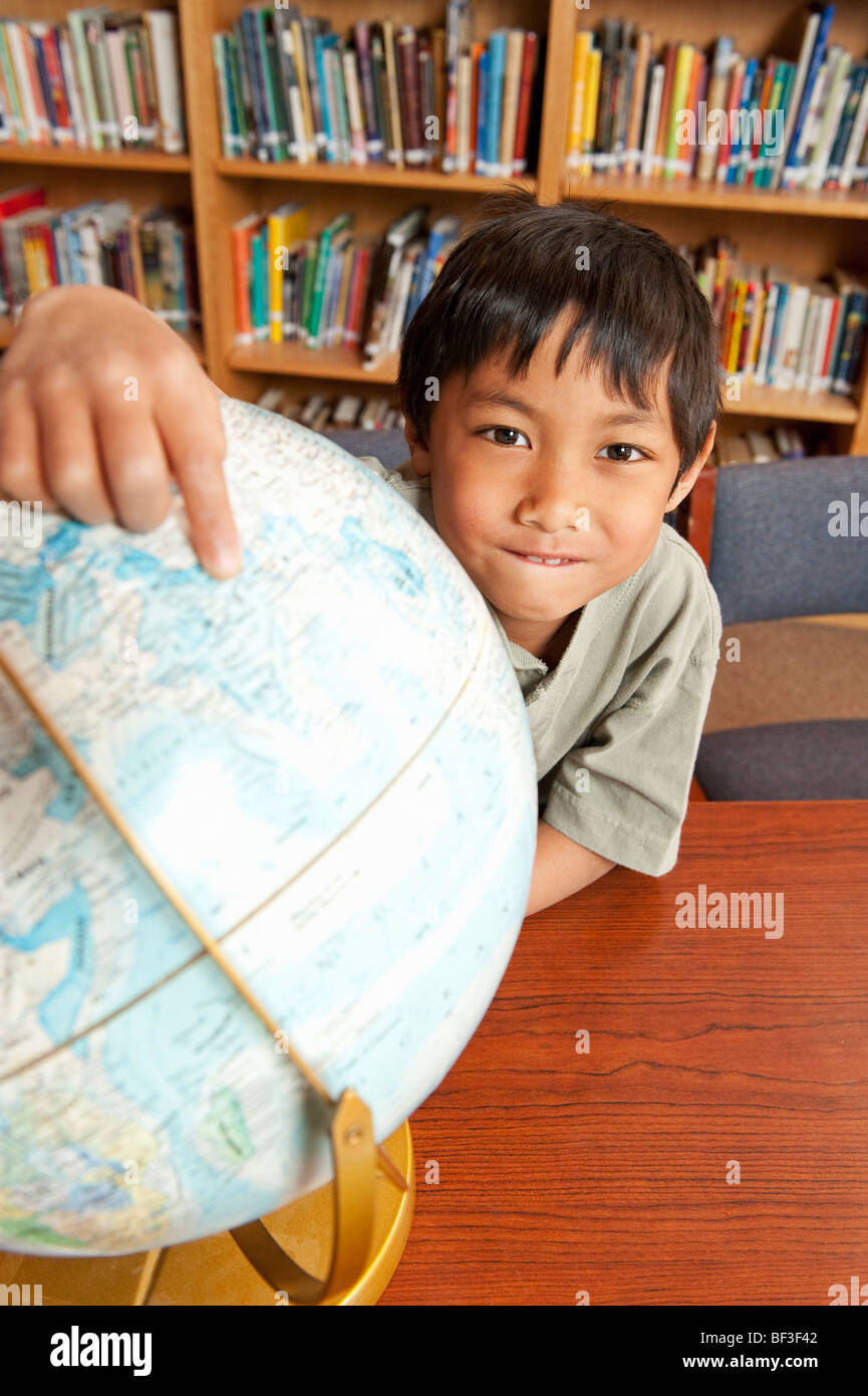 Student pointing to world globe Stock Photo - Alamy