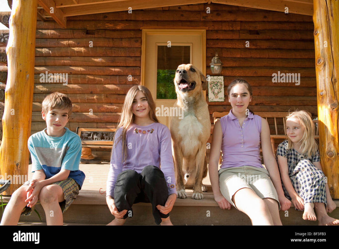 Portrait of kids and dog at home Stock Photo - Alamy