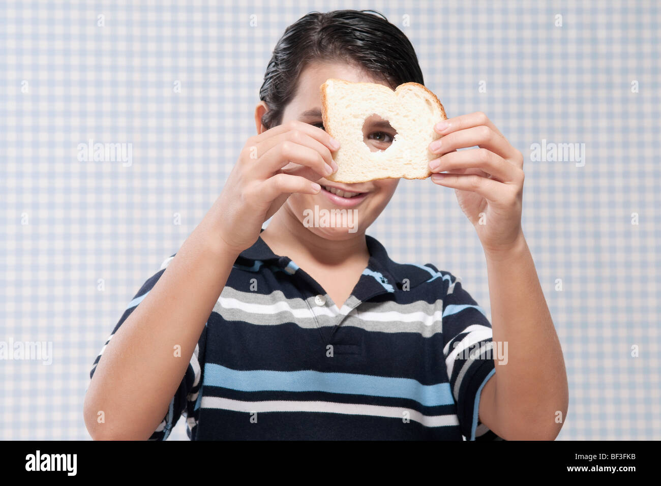 Boy holding a slice of bread Stock Photo - Alamy