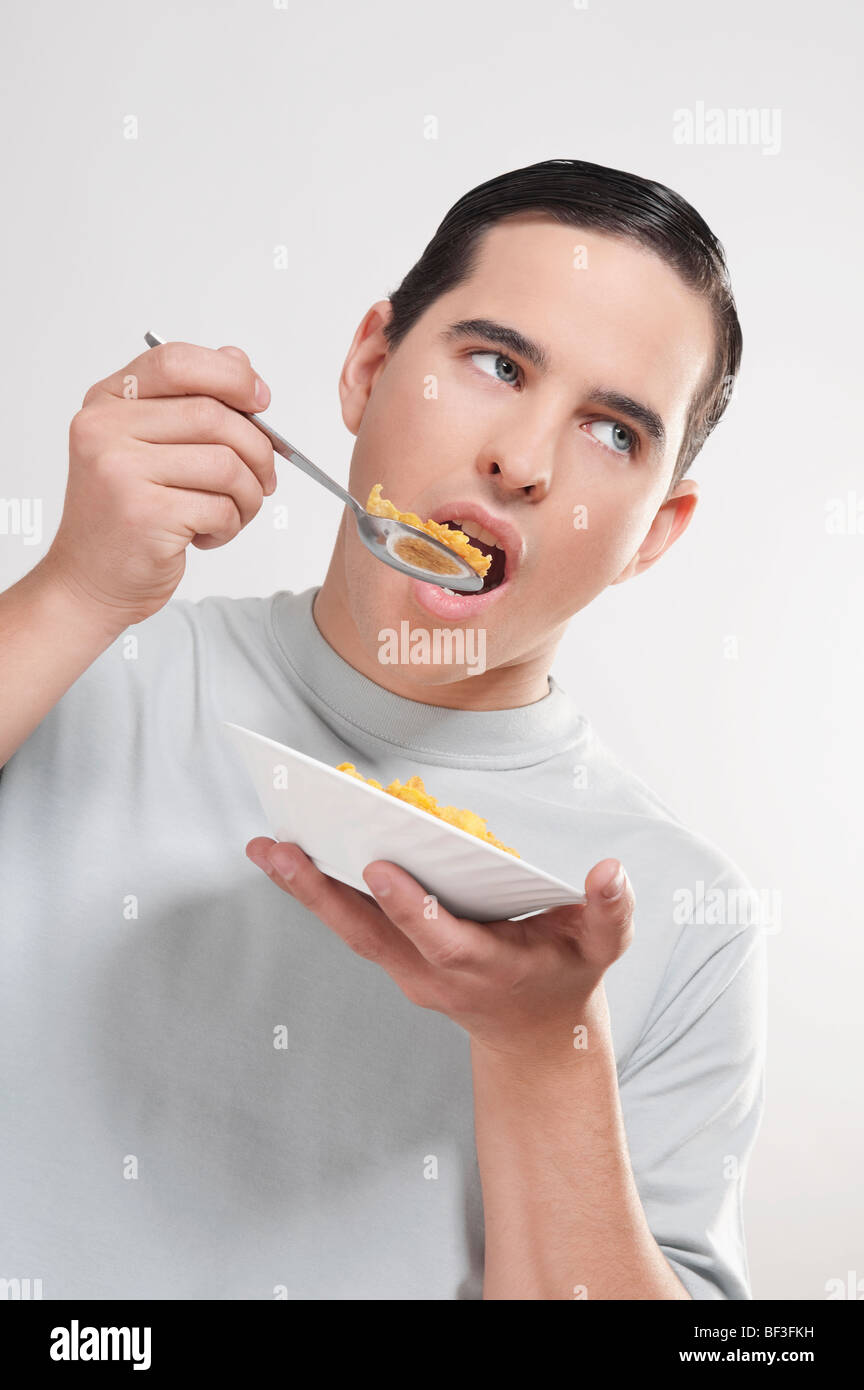 Man eating corn flakes Stock Photo - Alamy