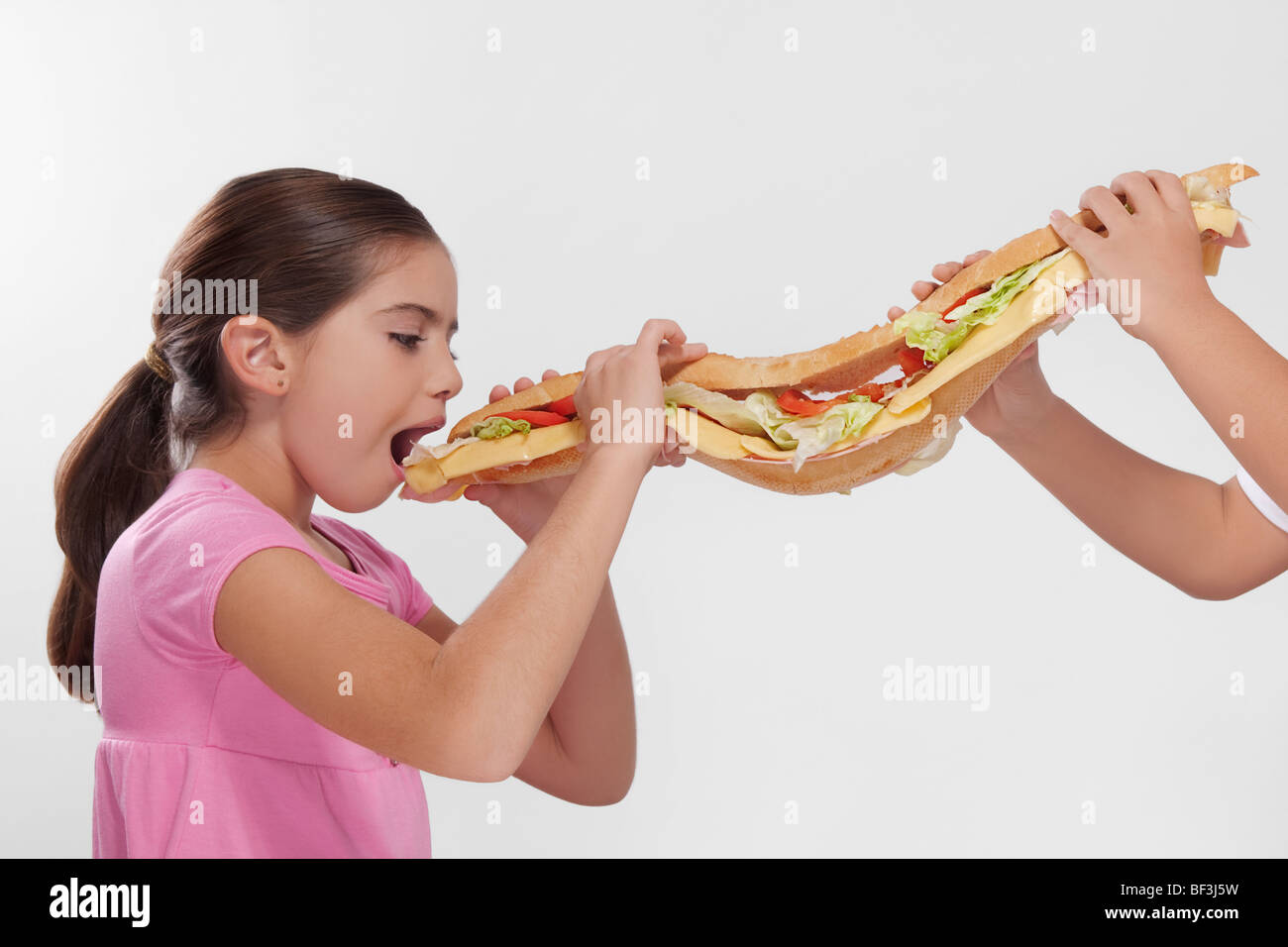 Two children eating submarine sandwich hi-res stock photography and ...