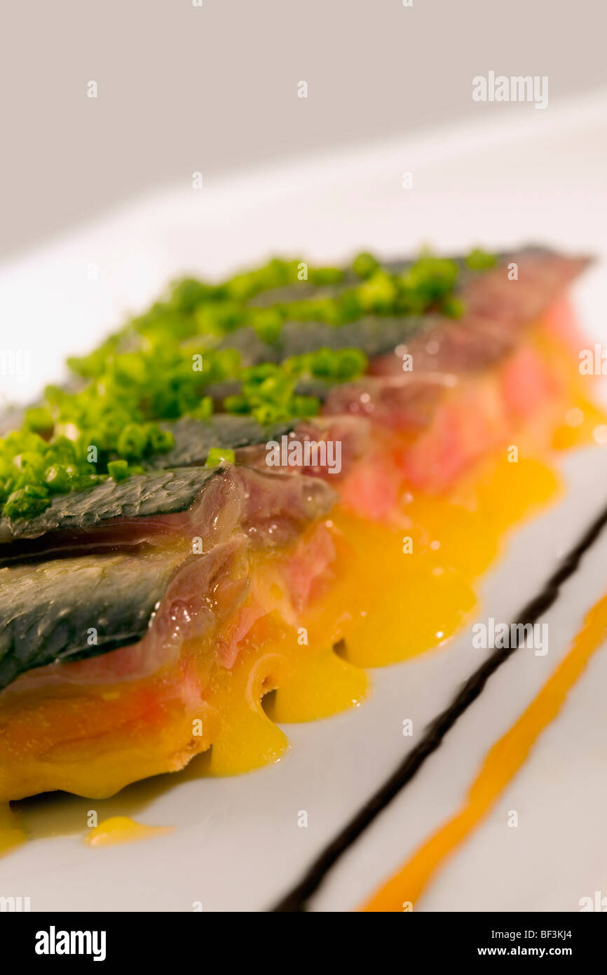 Close-up of a platter of fish garnished with leeks Stock Photo - Alamy