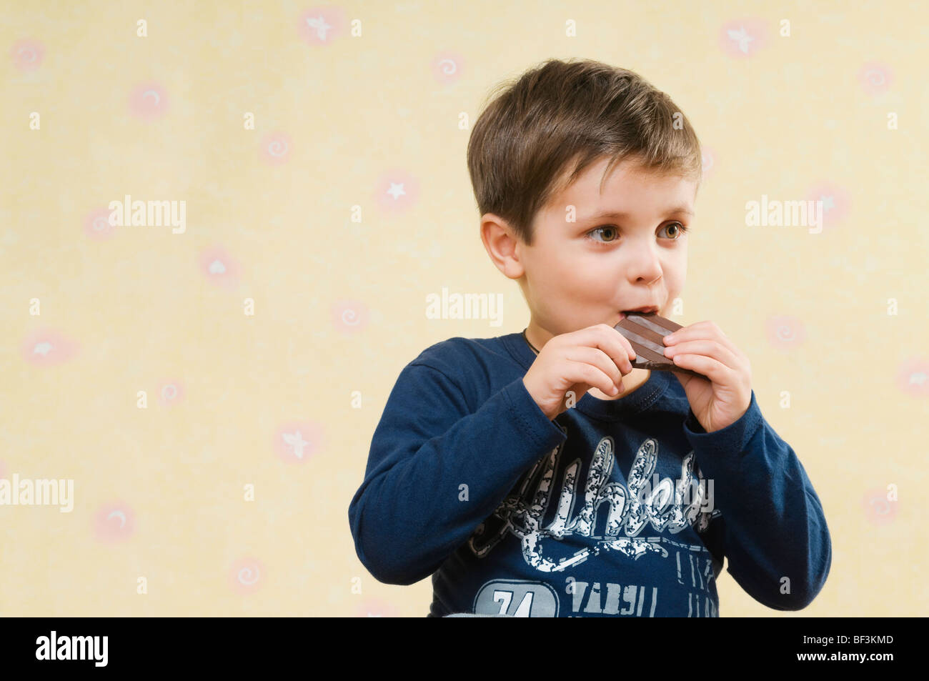 Boy eating a chocolate Stock Photo - Alamy