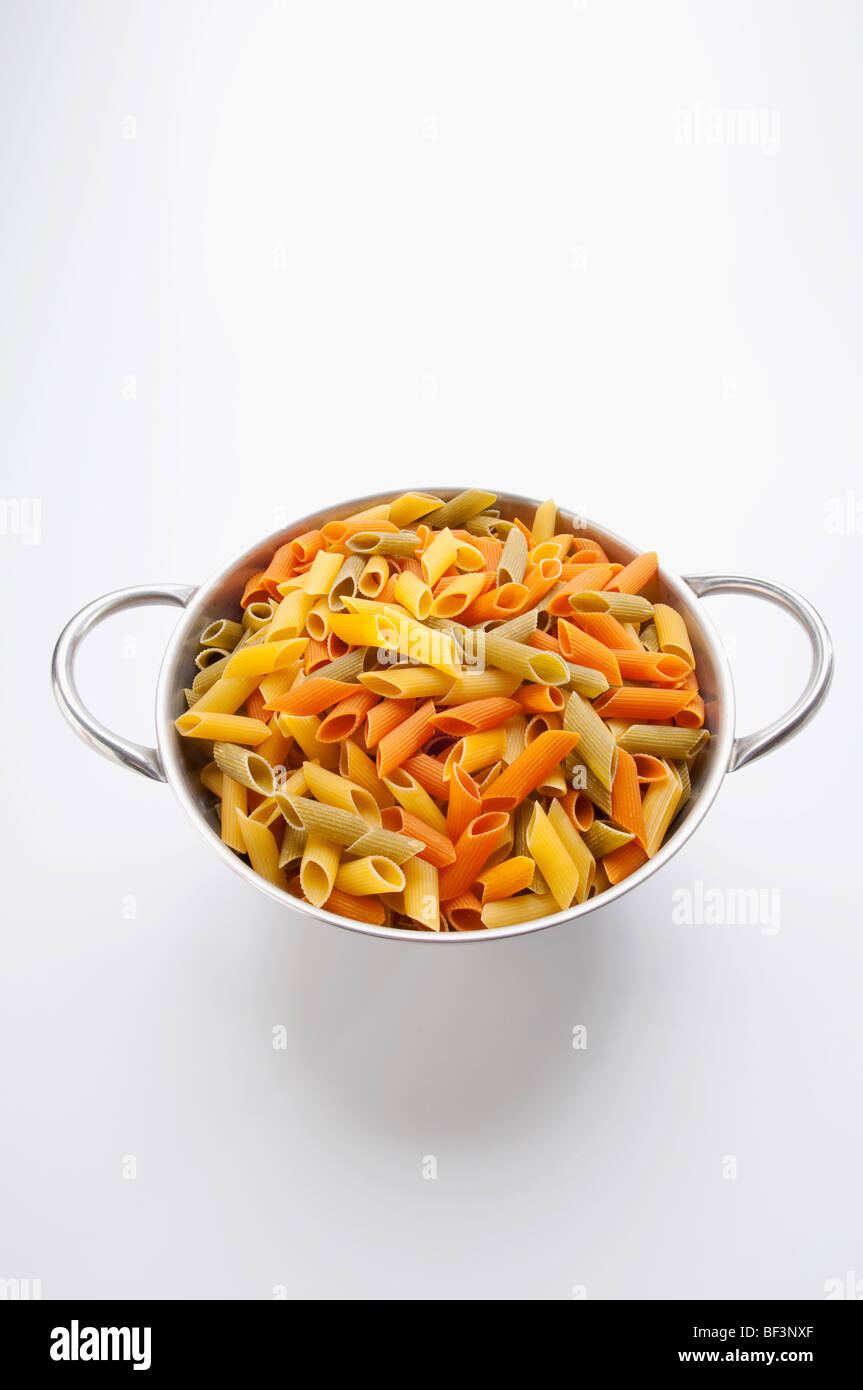 Multi colored rigatoni pasta in a strainer Stock Photo - Alamy