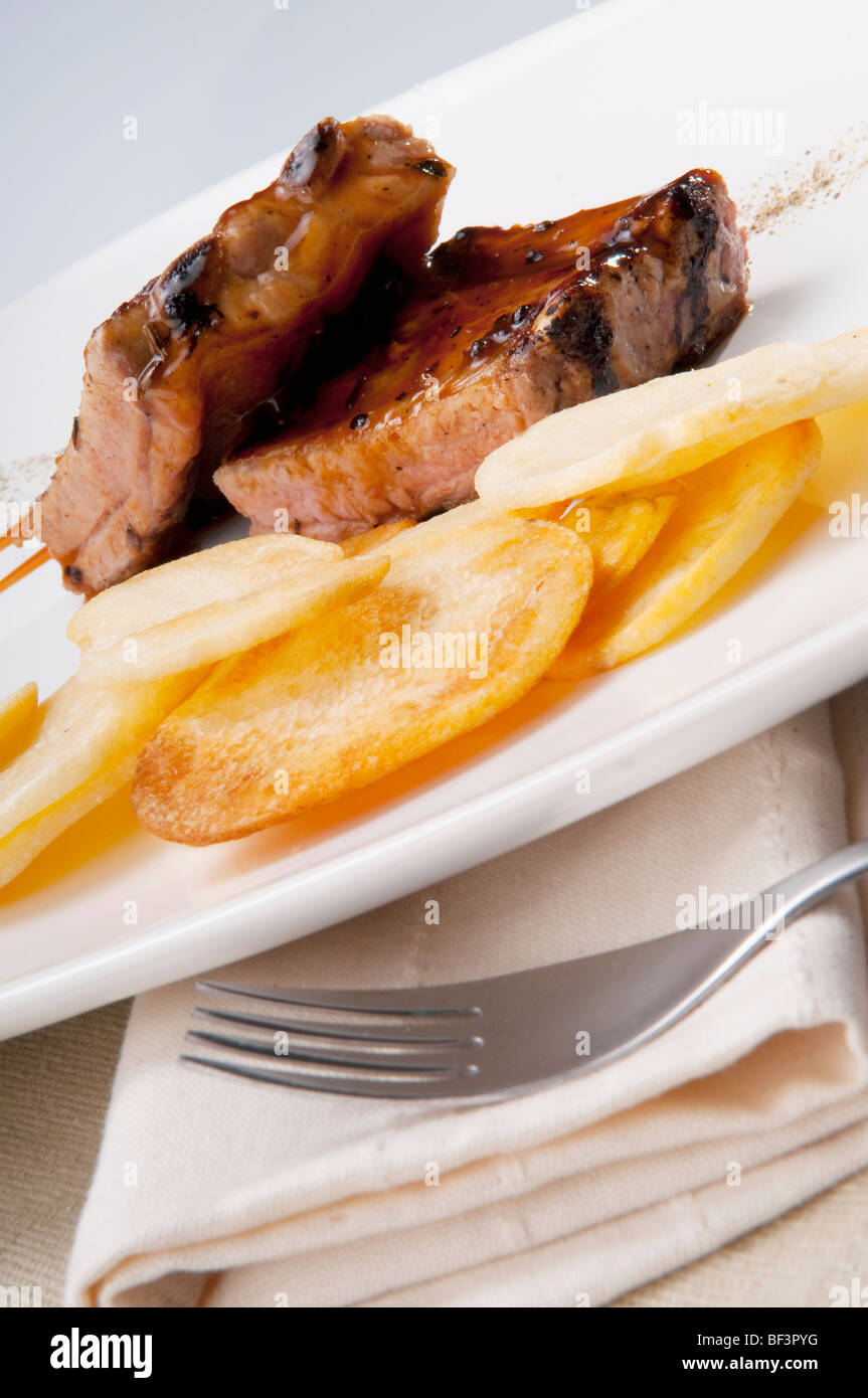 Close-up of spare ribs and chips Stock Photo - Alamy