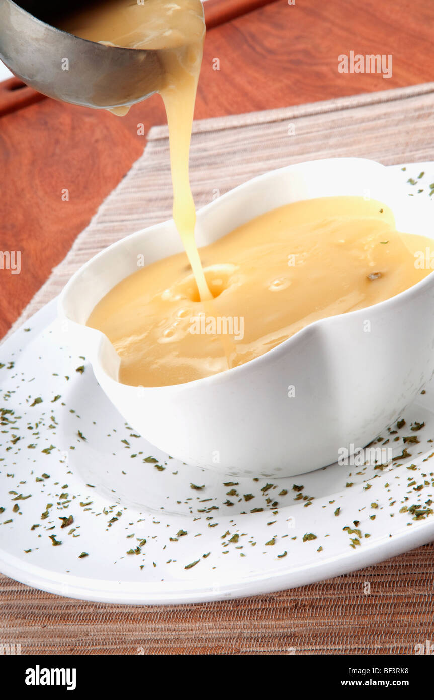Close-up of soup being poured into a bowl Stock Photo - Alamy