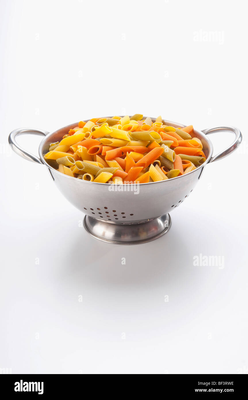 Multi colored rigatoni pasta in a strainer Stock Photo - Alamy