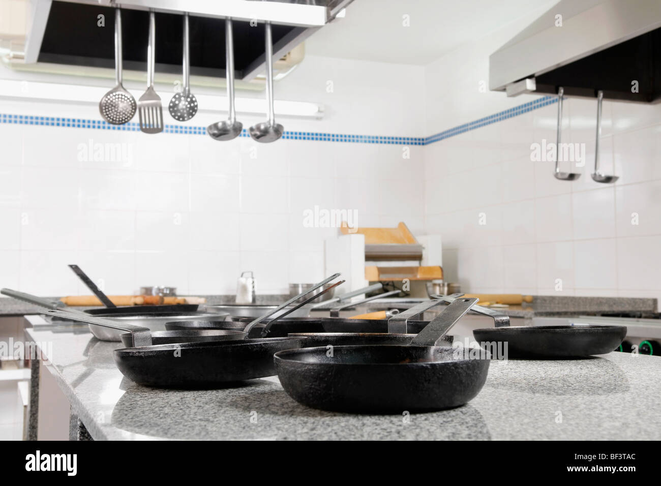 Frying pans in the kitchen Stock Photo - Alamy