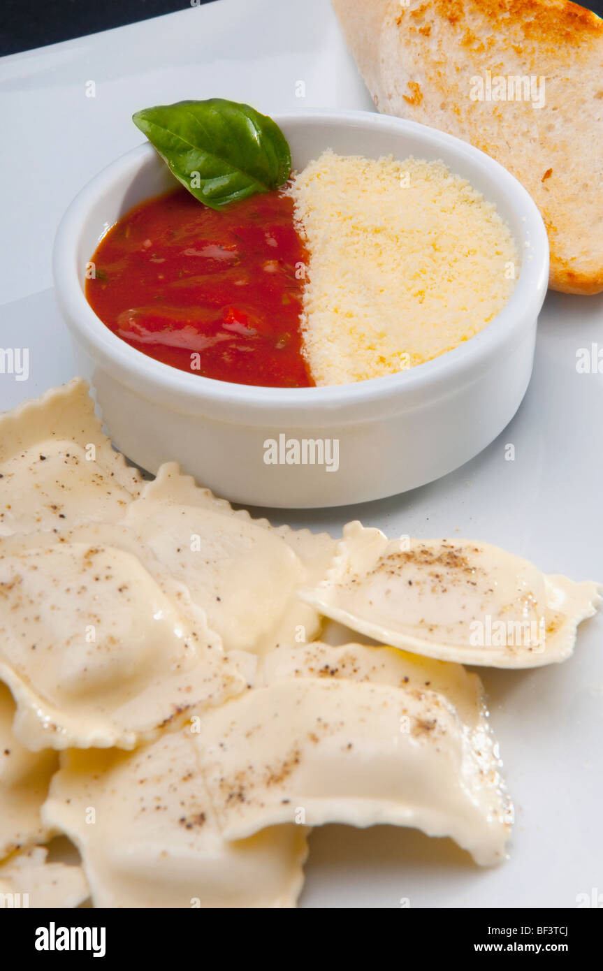Close up of ravioli served with tomato sauce and grated cheese hi-res ...