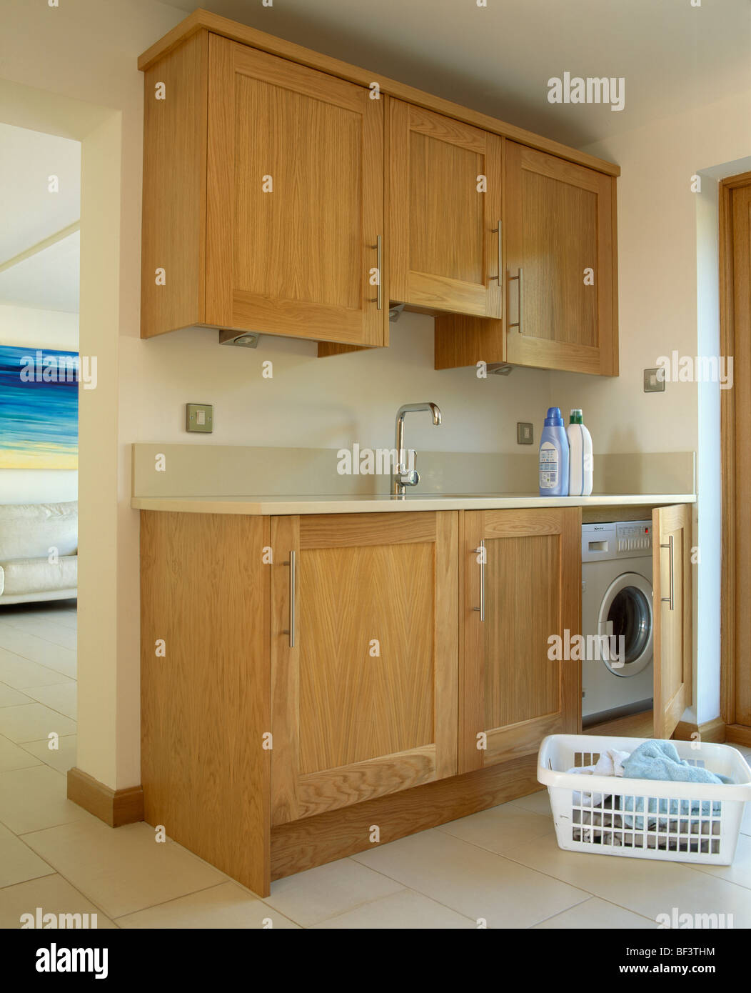 Fitted oak cupboards concealing washing machine in utility room Stock ...
