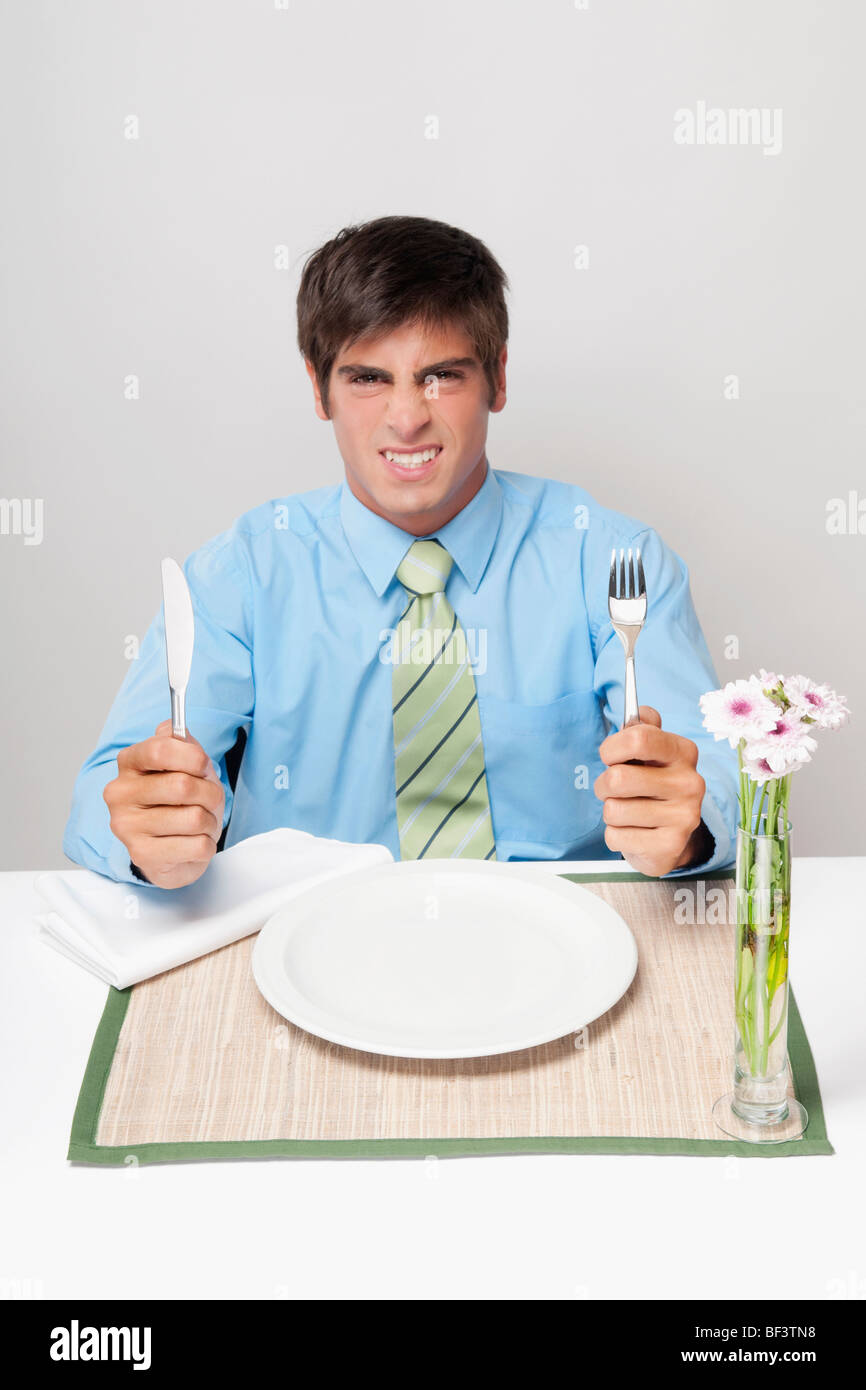 Portrait of a businessman getting angry waiting for dinner Stock Photo ...