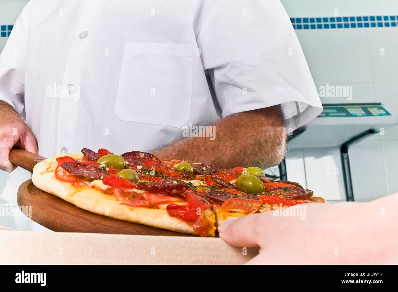 Two chefs preparing pizza in the kitchen Stock Photo - Alamy