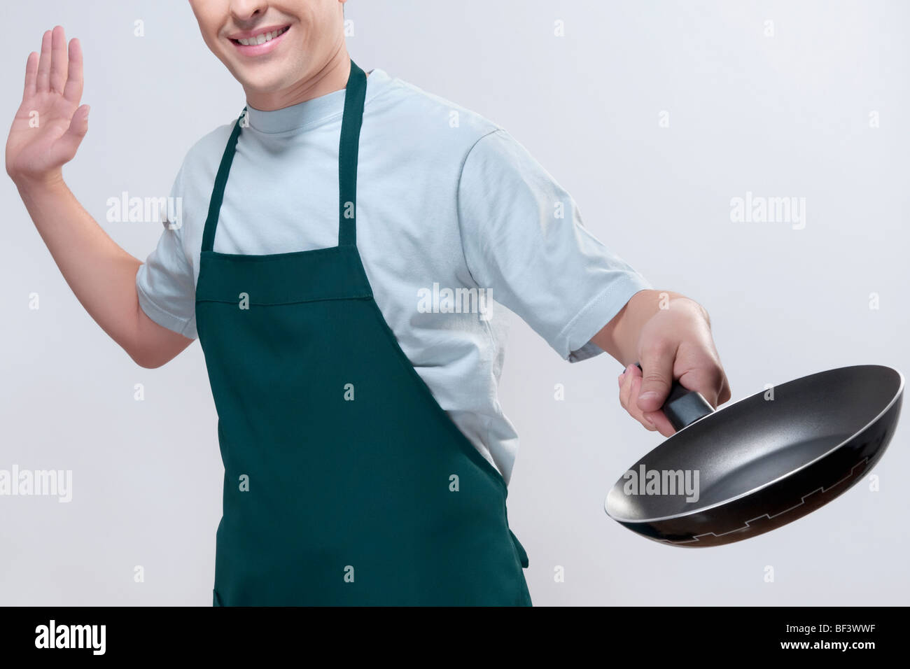 Man holding a frying pan Stock Photo - Alamy