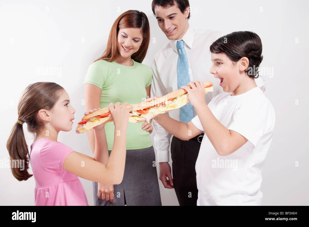 Two children eating submarine sandwich hi-res stock photography and ...