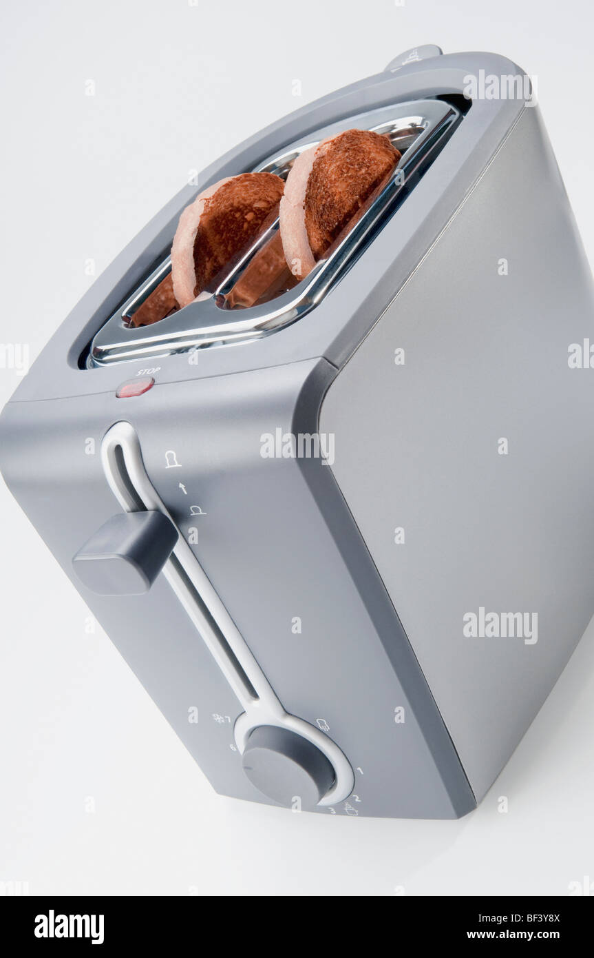 Burnt toasts in a toaster Stock Photo - Alamy