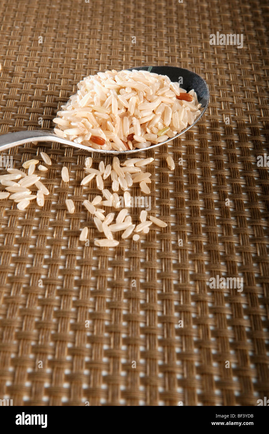 Close-up of brown rice on a spoon Stock Photo - Alamy