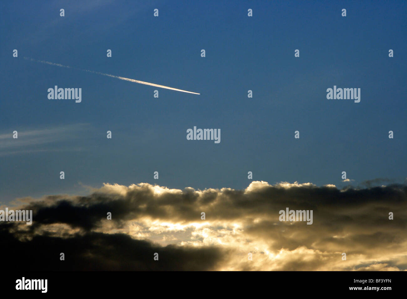 An aeroplane flying at sunset Stock Photo - Alamy