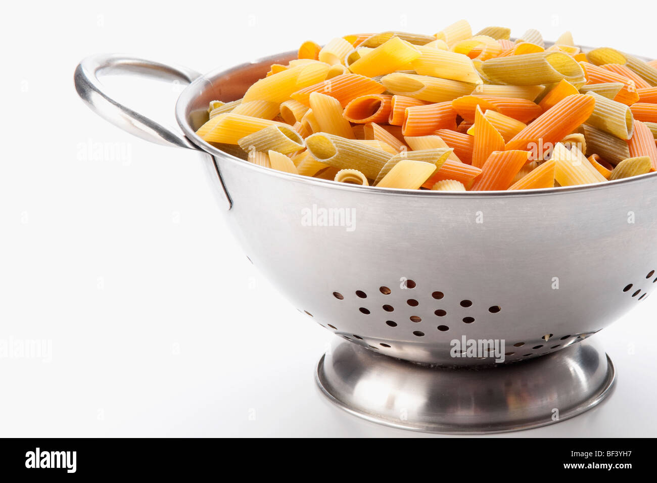 Multi colored rigatoni pasta in a strainer Stock Photo - Alamy