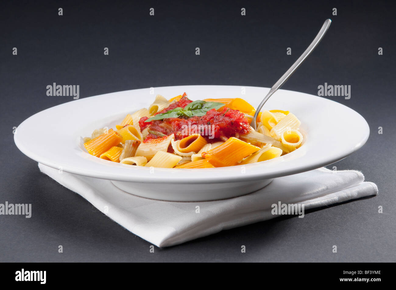 Dish of rigatoni pasta topped with tomato concasse Stock Photo - Alamy
