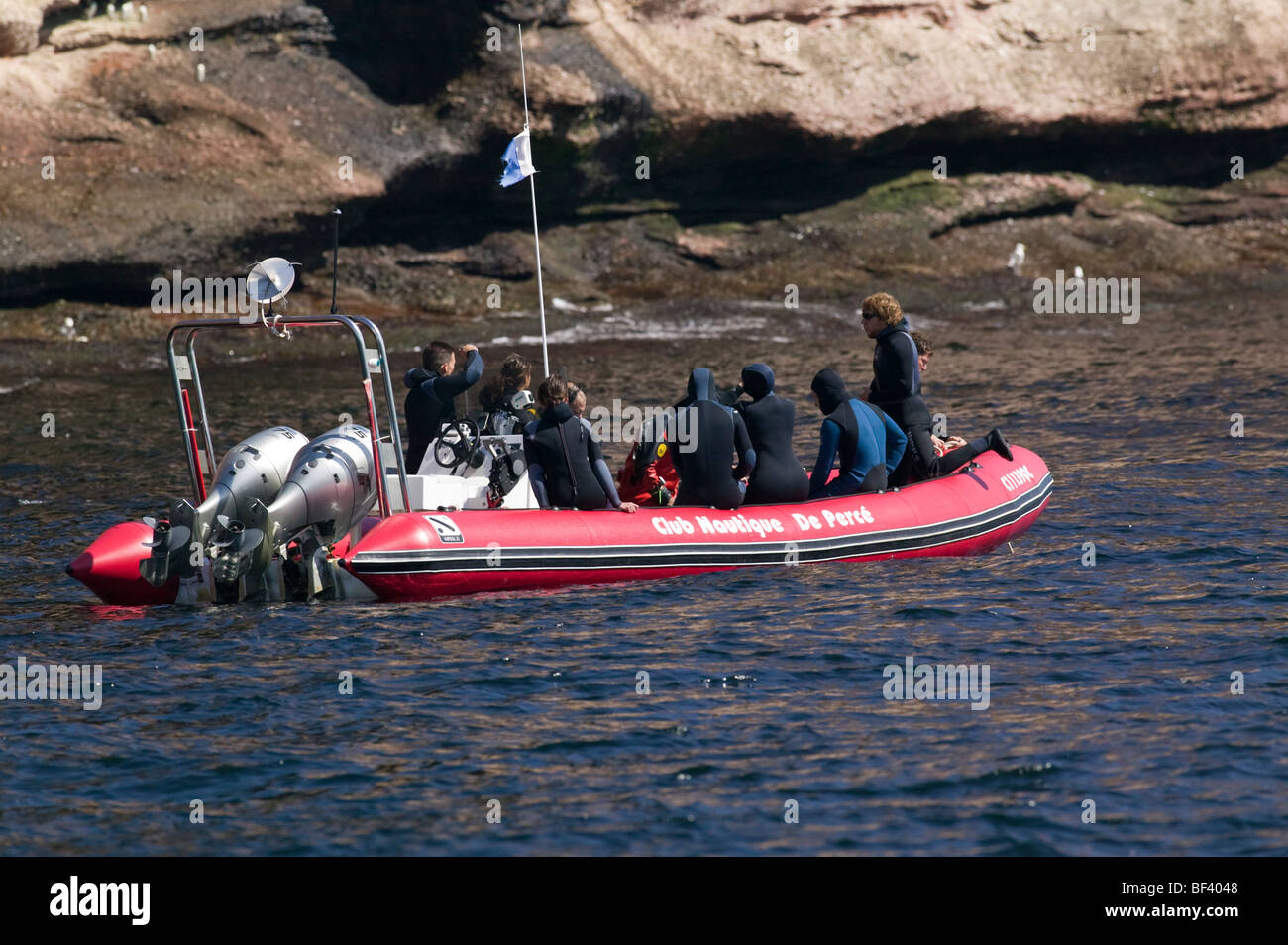 Divers on a raft preparing for a dive off the coast of Bonaventure ...