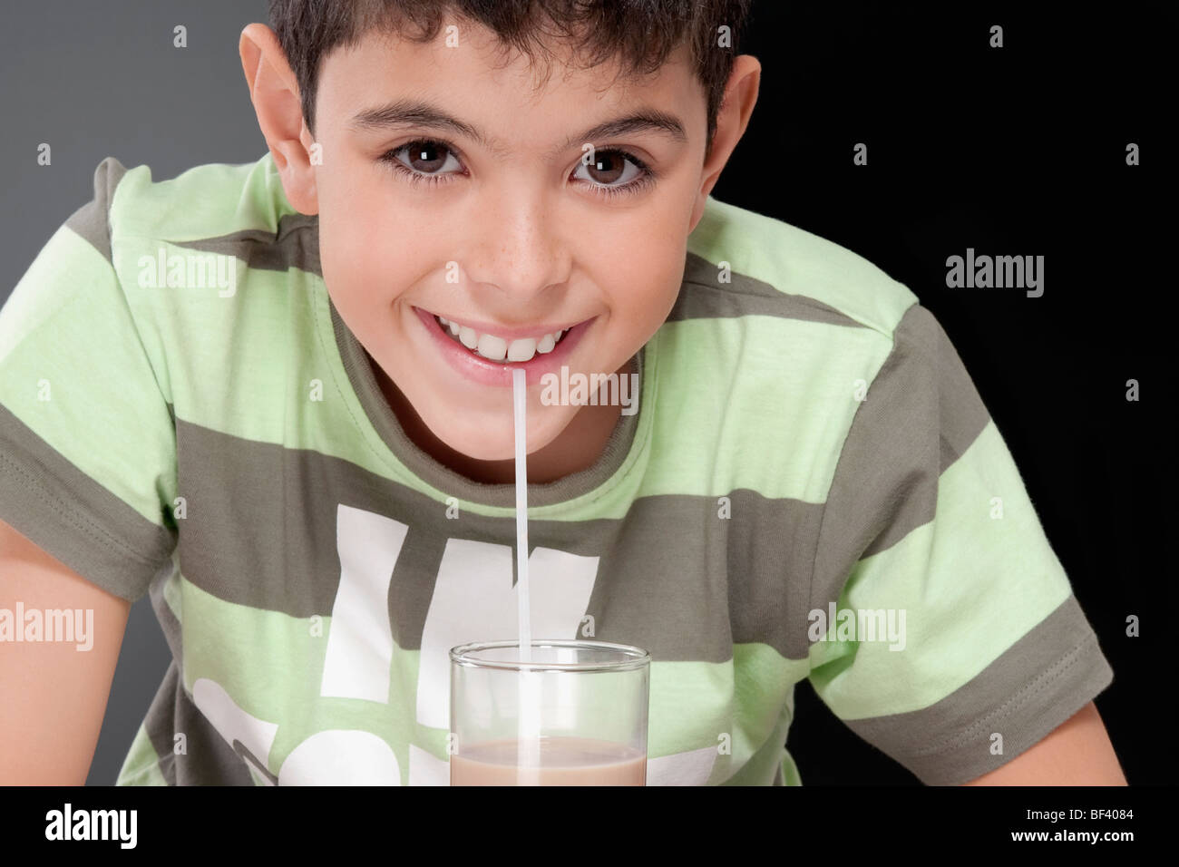 Boy drinking chocolate milkshake and smiling Stock Photo - Alamy