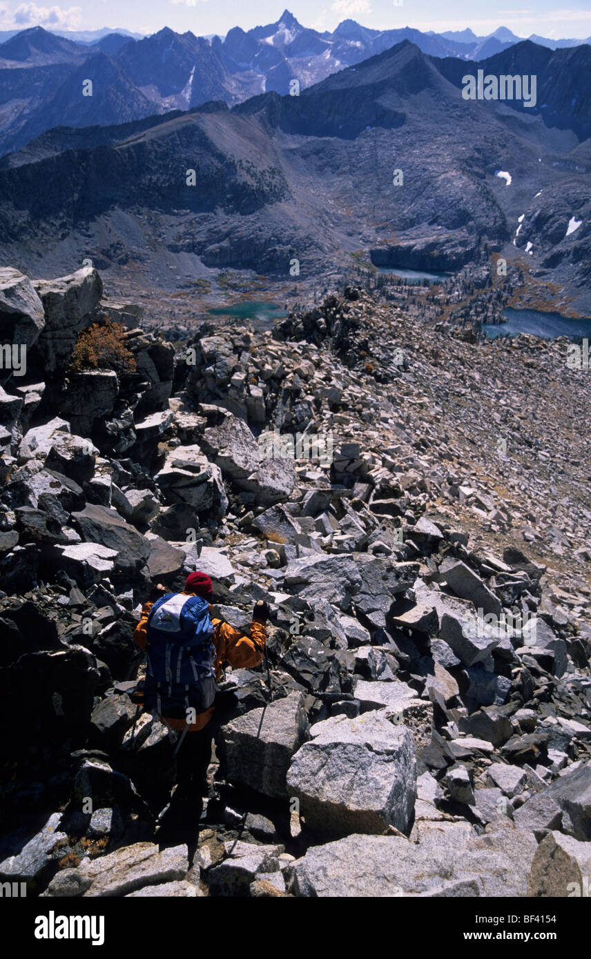 Man backpacking down rocks Stock Photo - Alamy