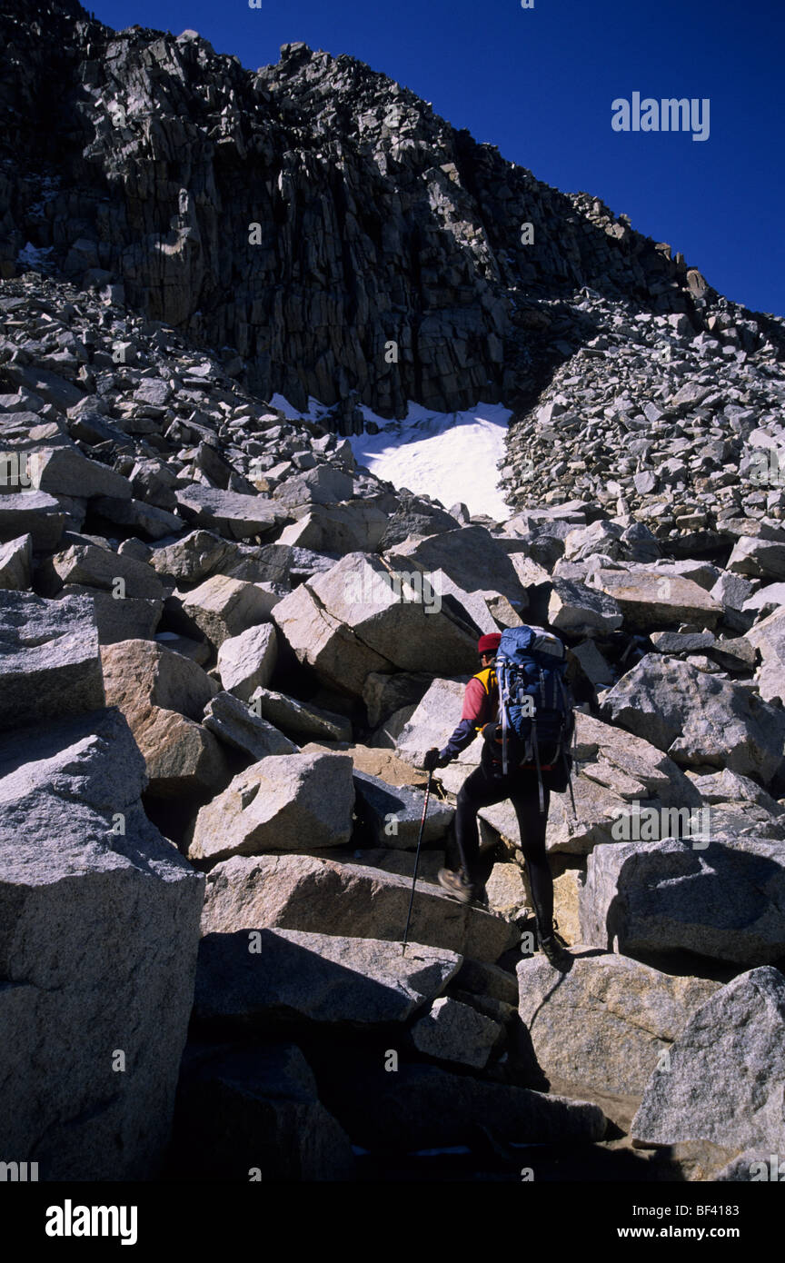 Man backpacking through rocks Stock Photo - Alamy