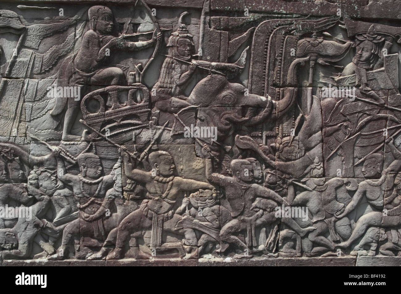 Frieze depicting procession of figures with spears and archer riding an ...