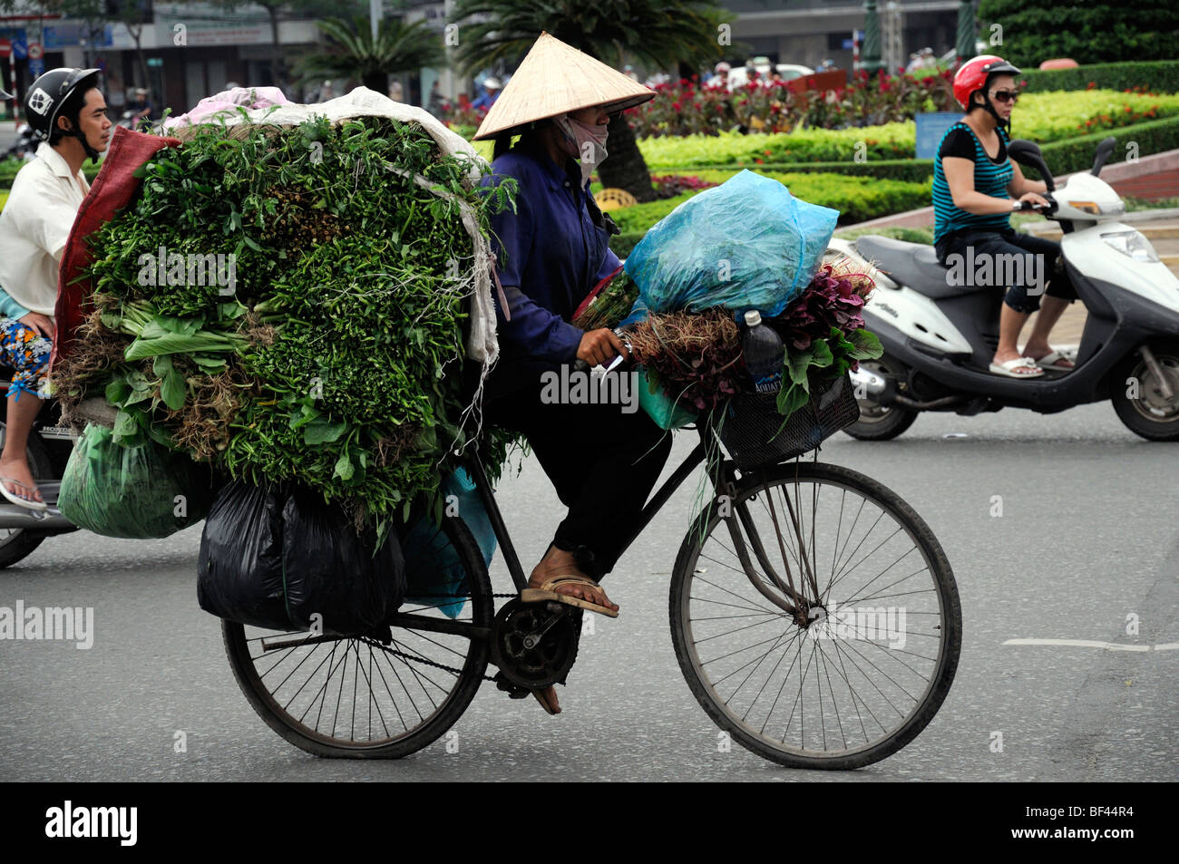woman carrying transporting carry transport very heavy load overloaded ...