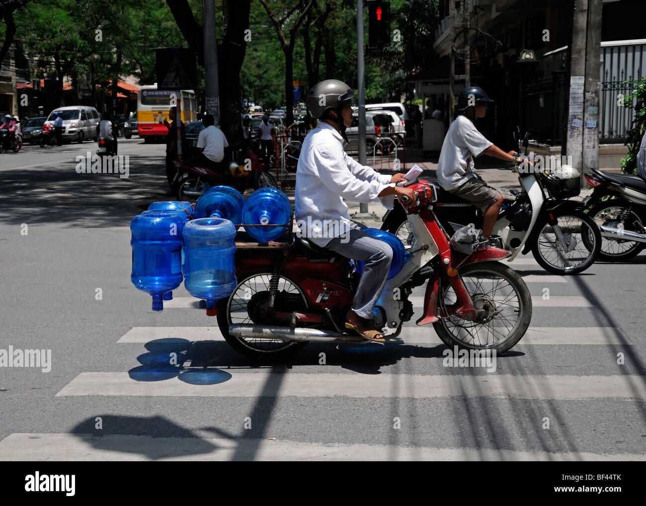 man carrying transporting carry transport very heavy load overloaded ...