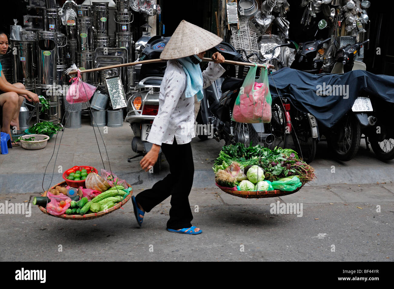 woman carrying transporting carry transport very heavy load overloaded ...