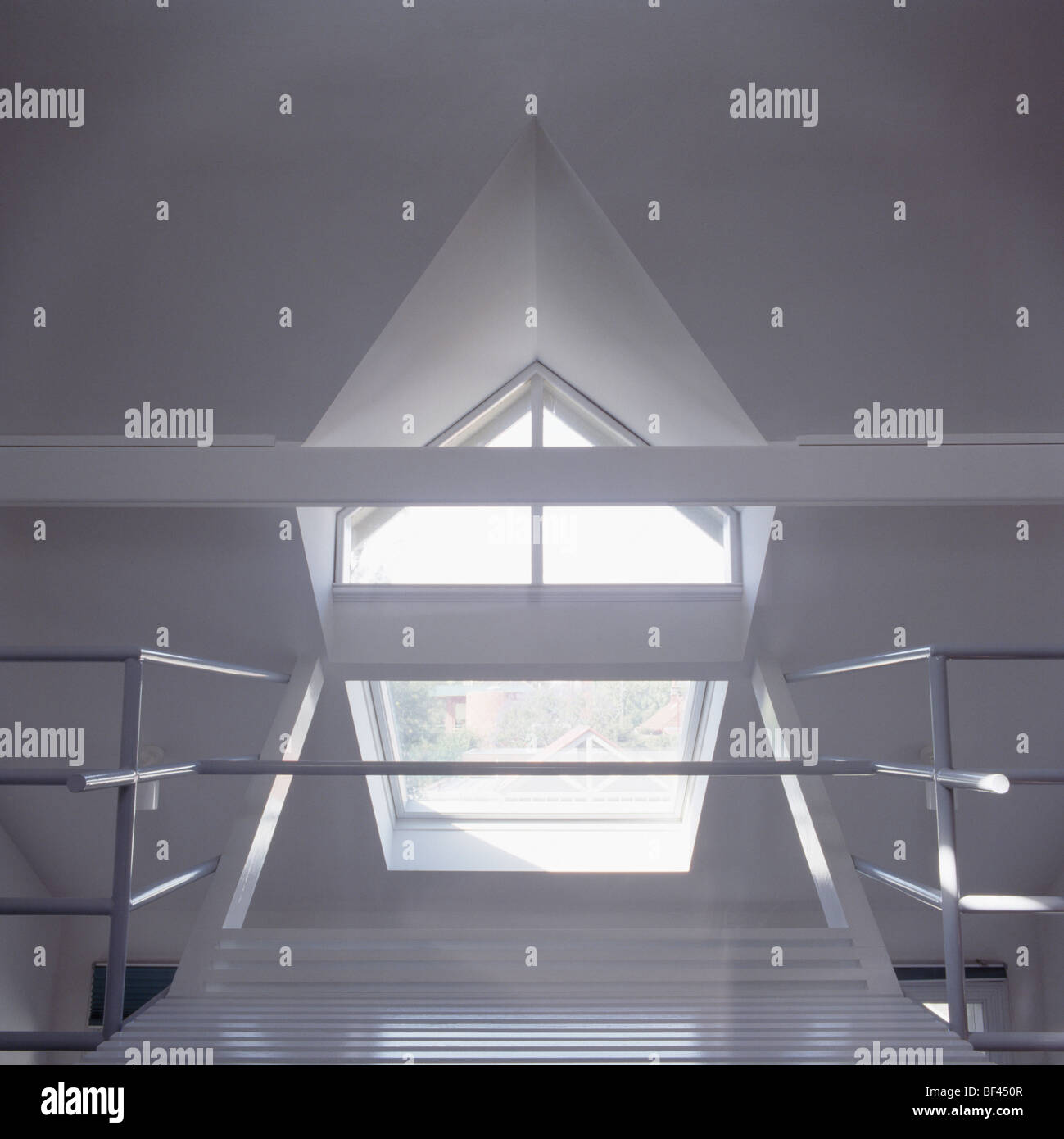 Close-up of dormer window and metal banisters in modern white attic ...