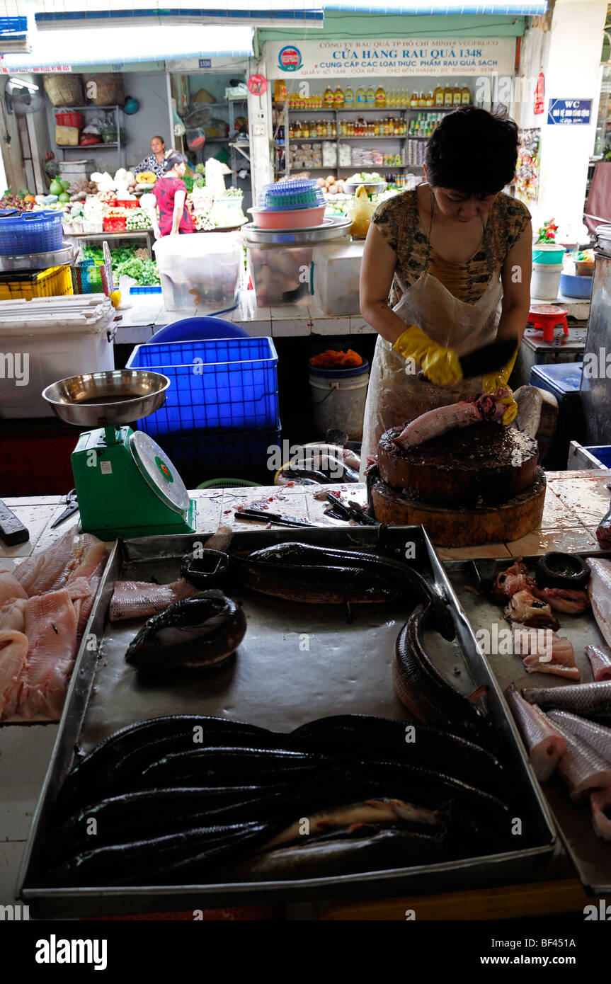 woman prepare preparing fish products for sale in the open air market ...