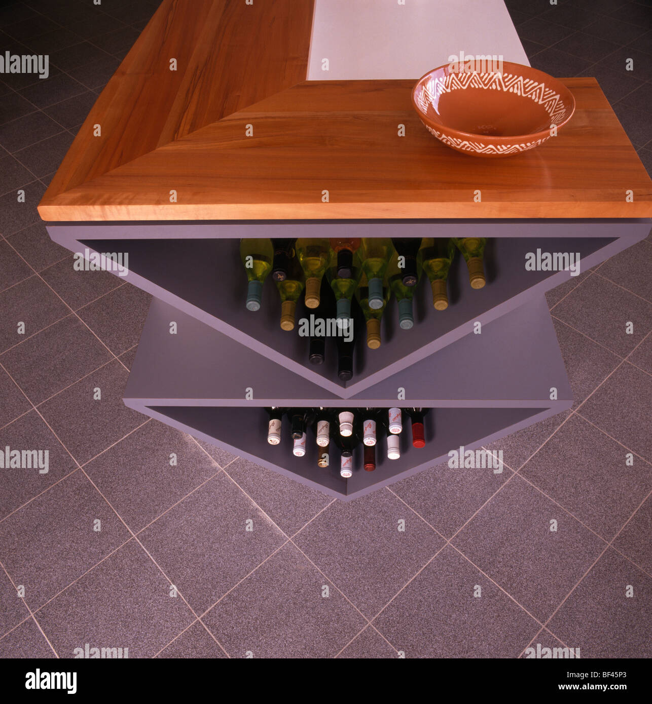 Close-up of triangular-shaped wine storage in modern island unit Stock ...