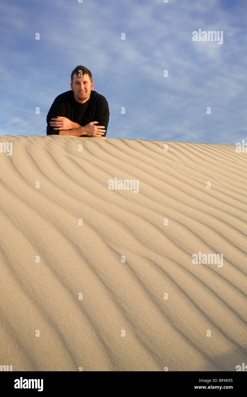 Man on a sand dune Stock Photo - Alamy
