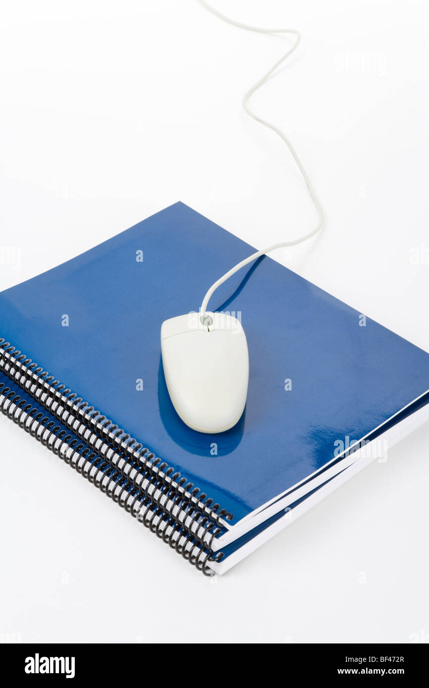 Blue school textbook and computer mouse, online learning Stock Photo ...