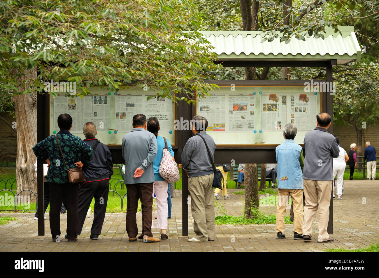 A group of elderly reading the newspaper display in Tiantan Park ...
