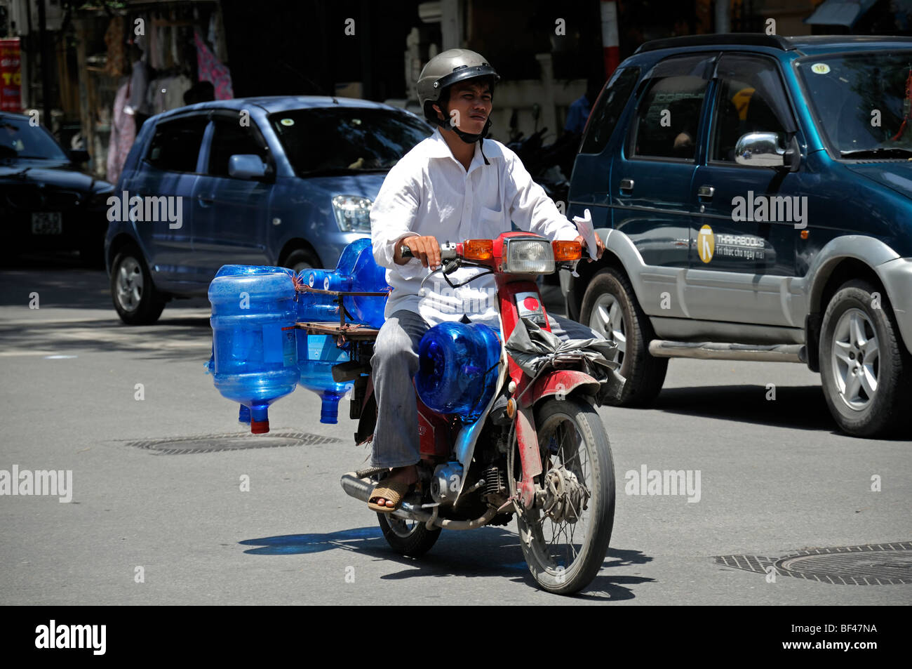 man carrying transporting carry transport very heavy load overloaded ...