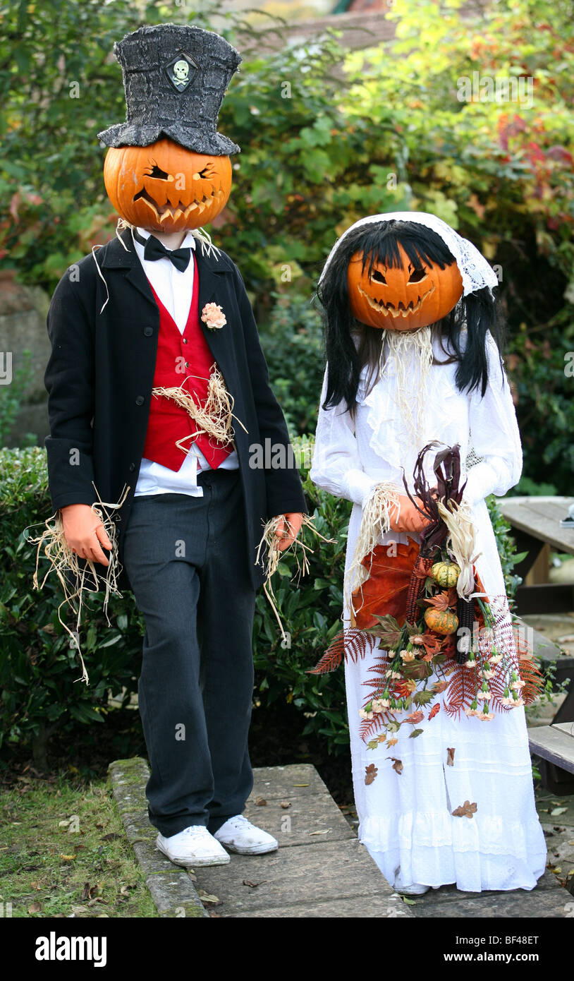 Boy and girl dressed with pumpkin heads at the Halloween competition in ...