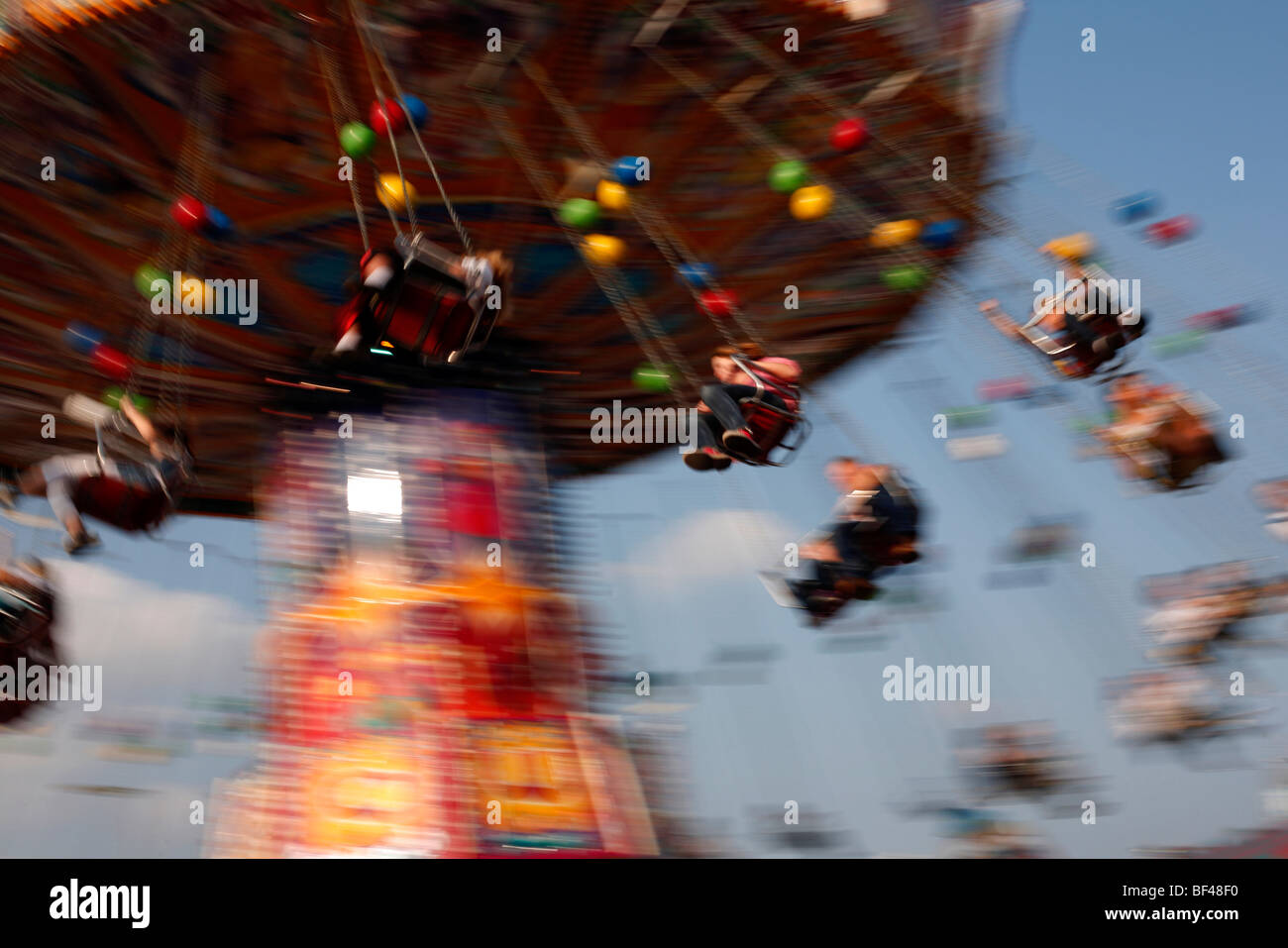 People on a fairground ride at a funfair Stock Photo - Alamy