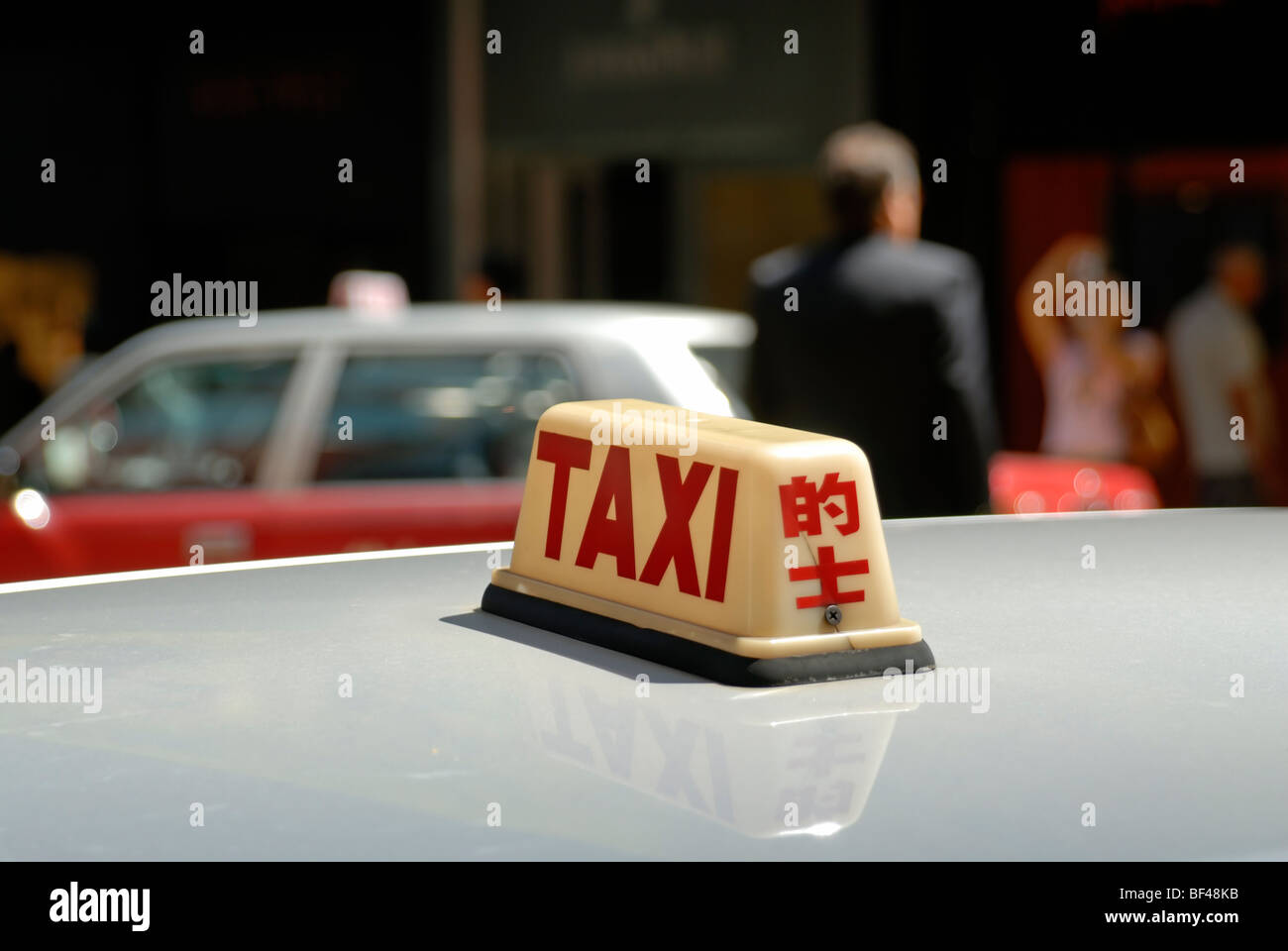 Hong Kong Businessman and Taxi sign Stock Photo - Alamy